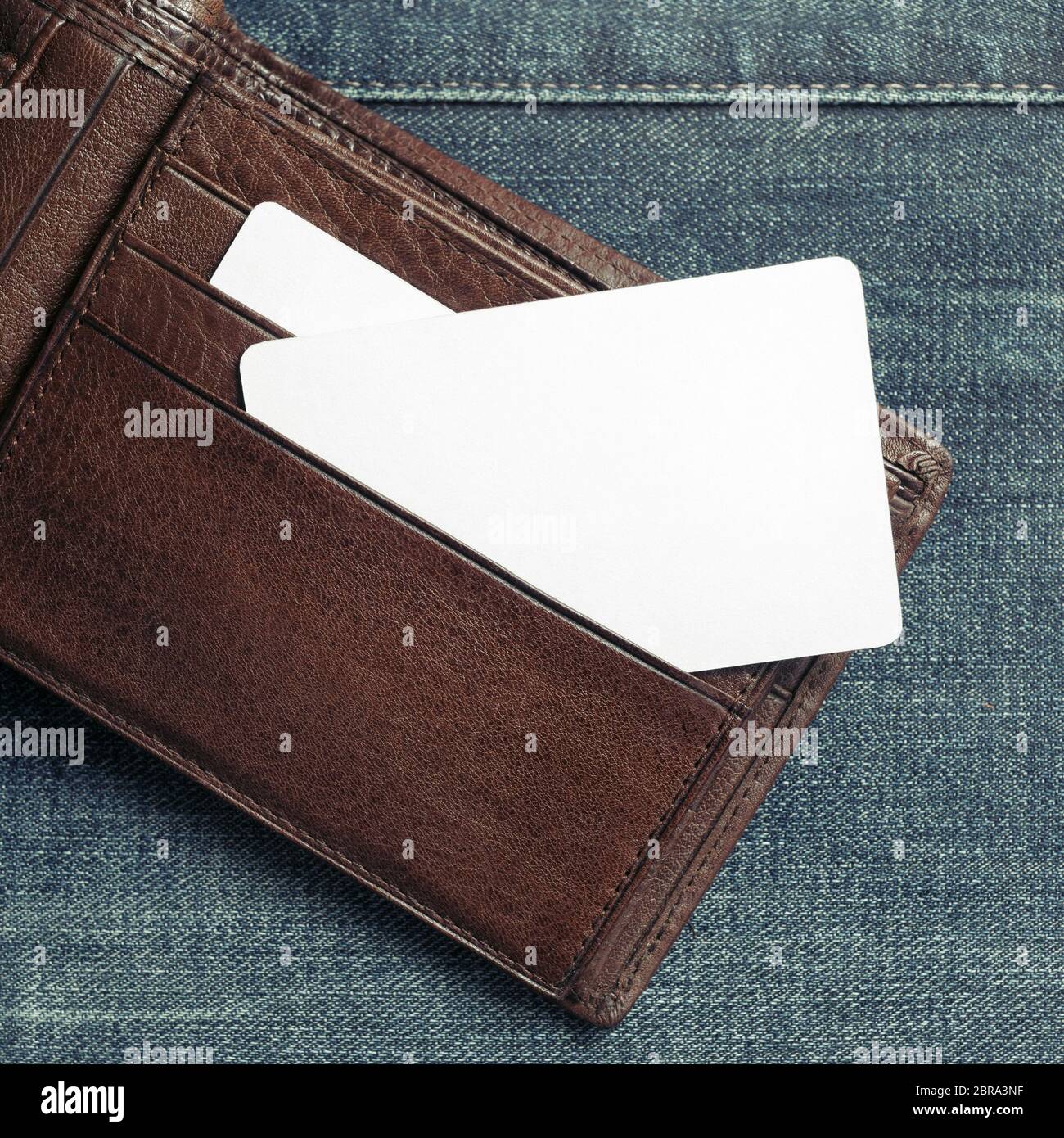 Blank business card or discount card in leather wallet on denim ...