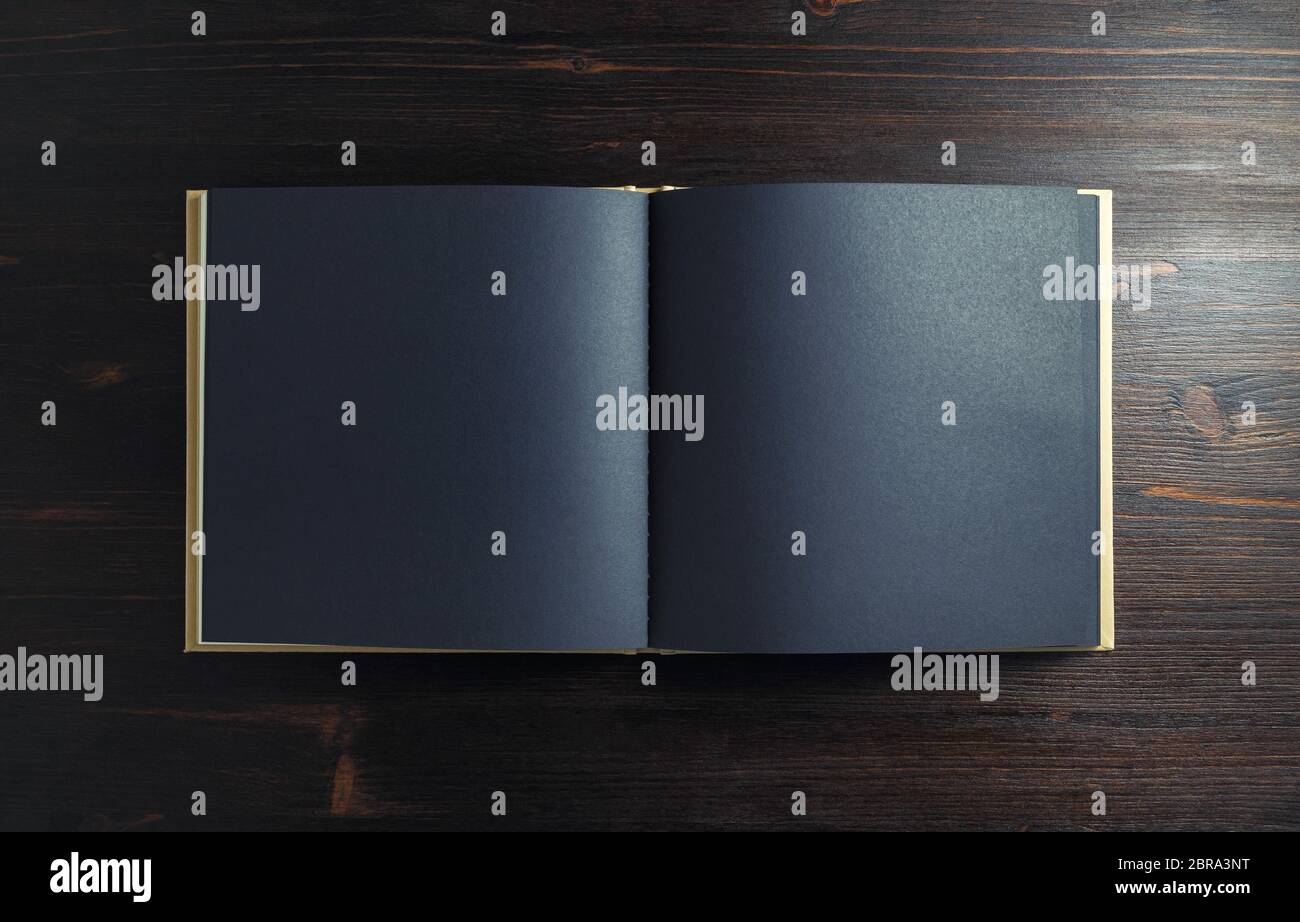 Photo of blank black booklet or brochure on dark wood table background ...