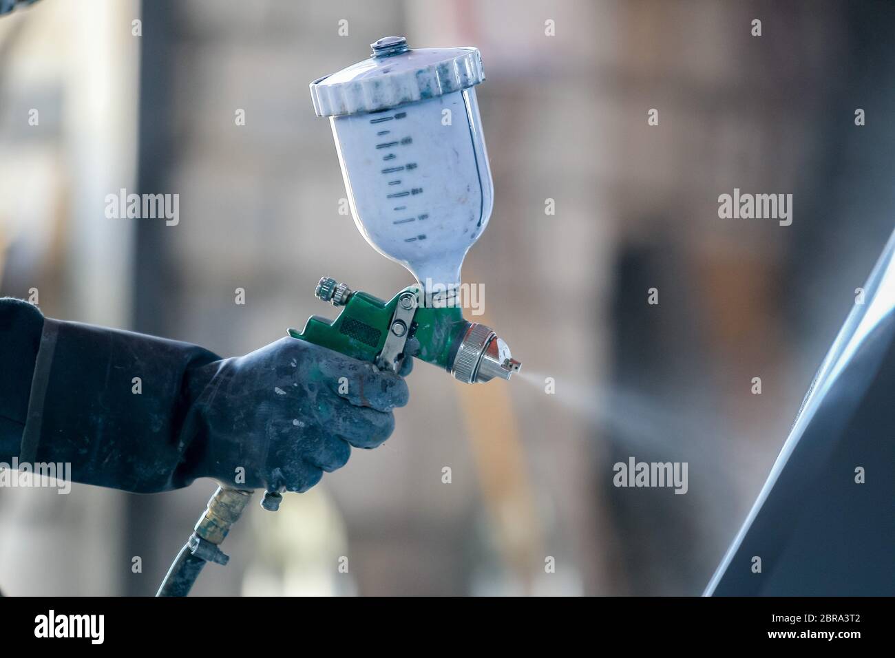 Master painting metal a spray Stock Photo - Alamy