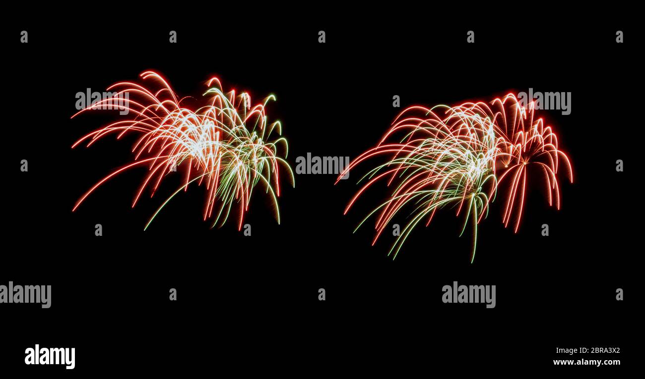 Red and green exploded fireworks display, isolated on black background ...