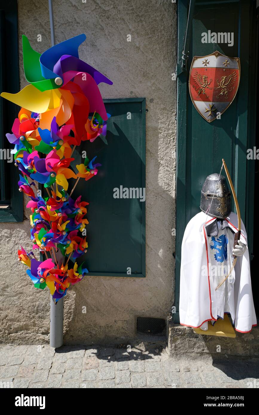 Colorful pinwheels and Knight's uniform and helmet display outside of a ...