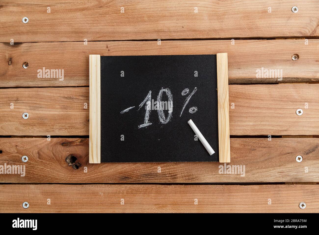 chalk Board with the inscription -10 percent on a wooden background ...