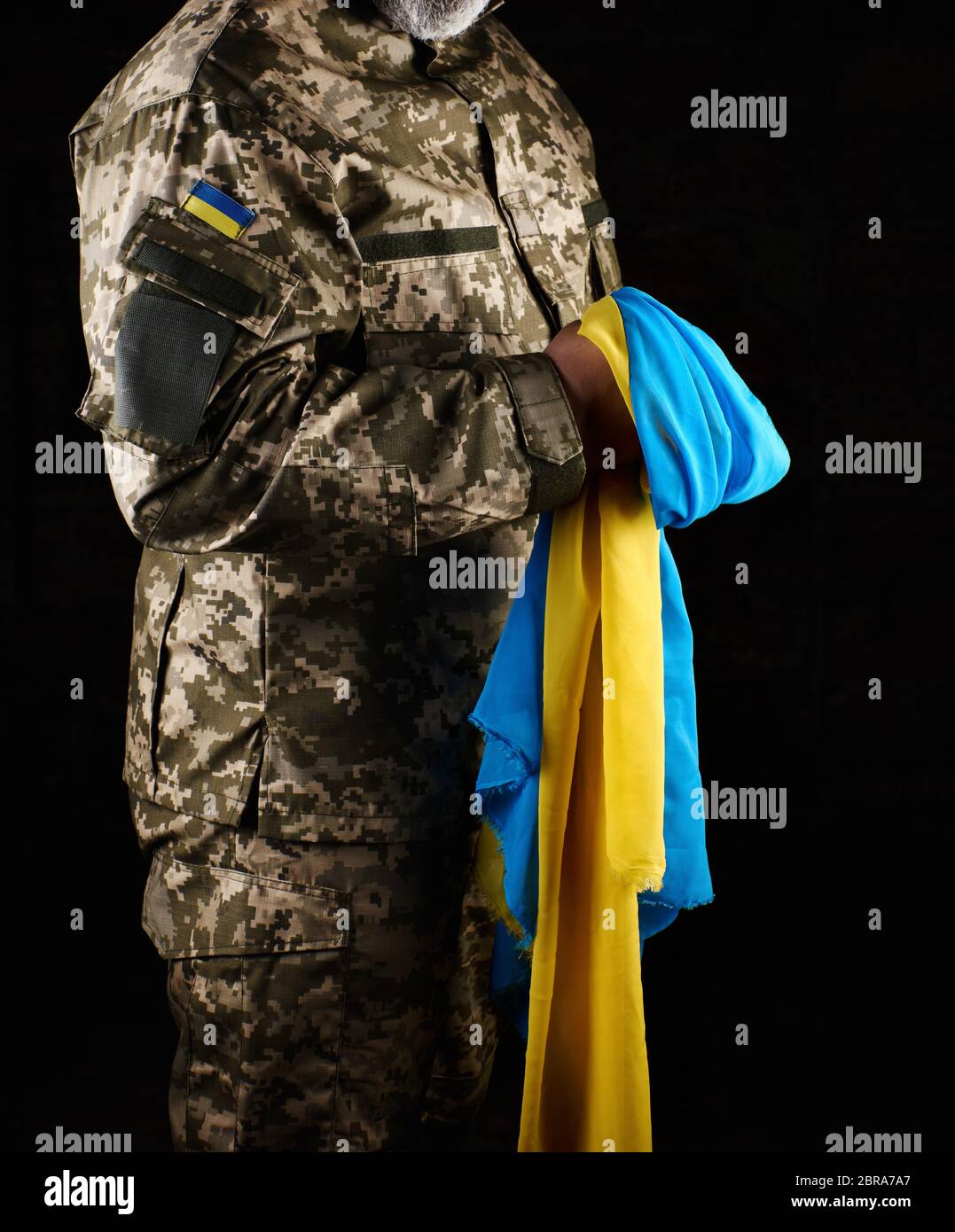 male soldier dressed in a military uniform of the Ukrainian army, he ...