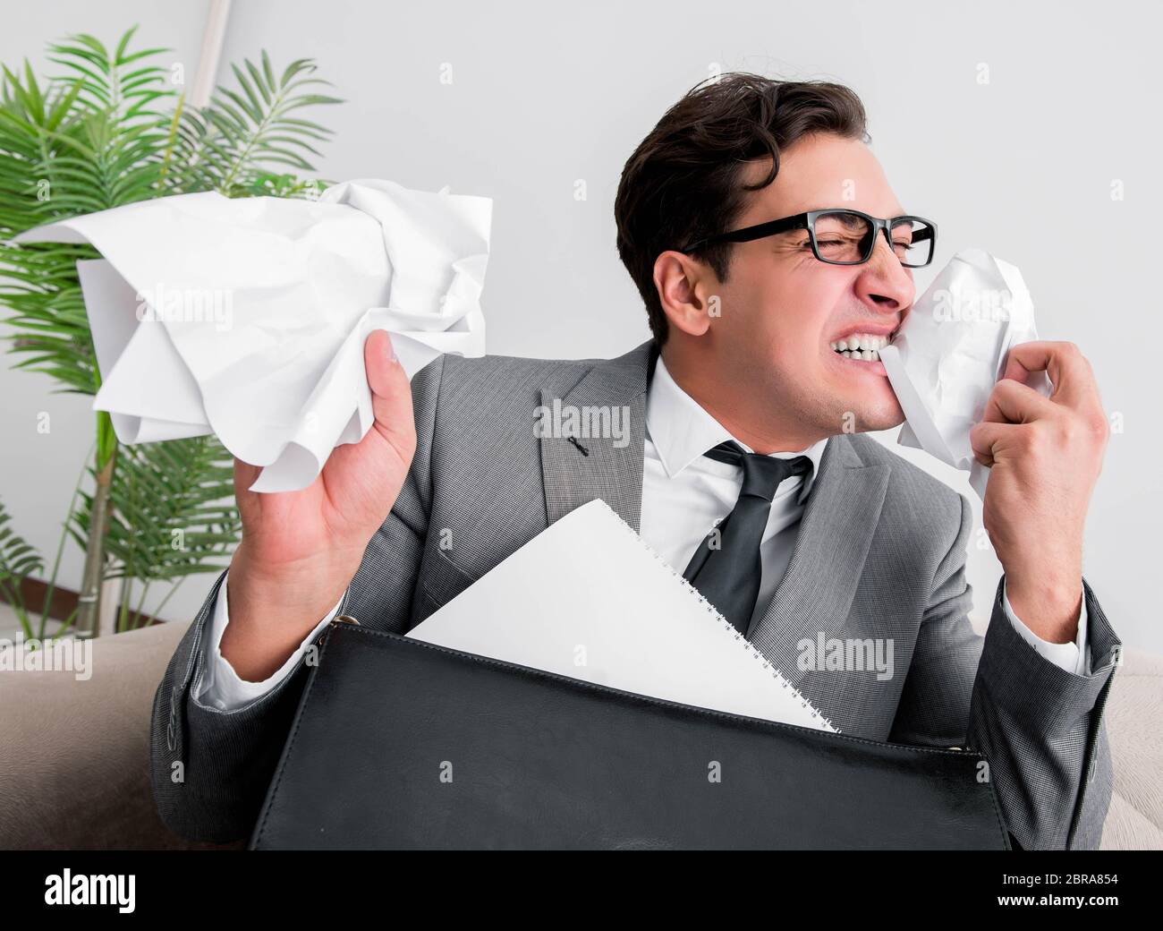 The angry businessman with crumbled paper Stock Photo - Alamy