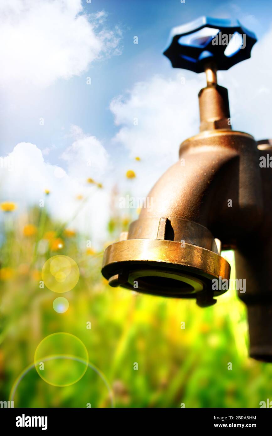 Water tap in nature scenery with bokeh Stock Photo - Alamy