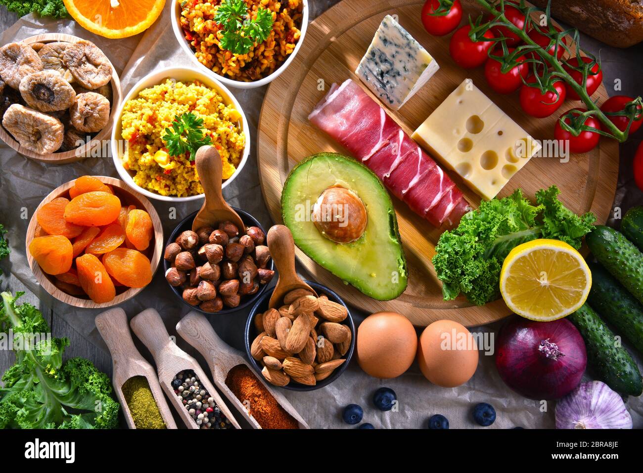 Composition with assorted food products on kitchen table Stock Photo ...