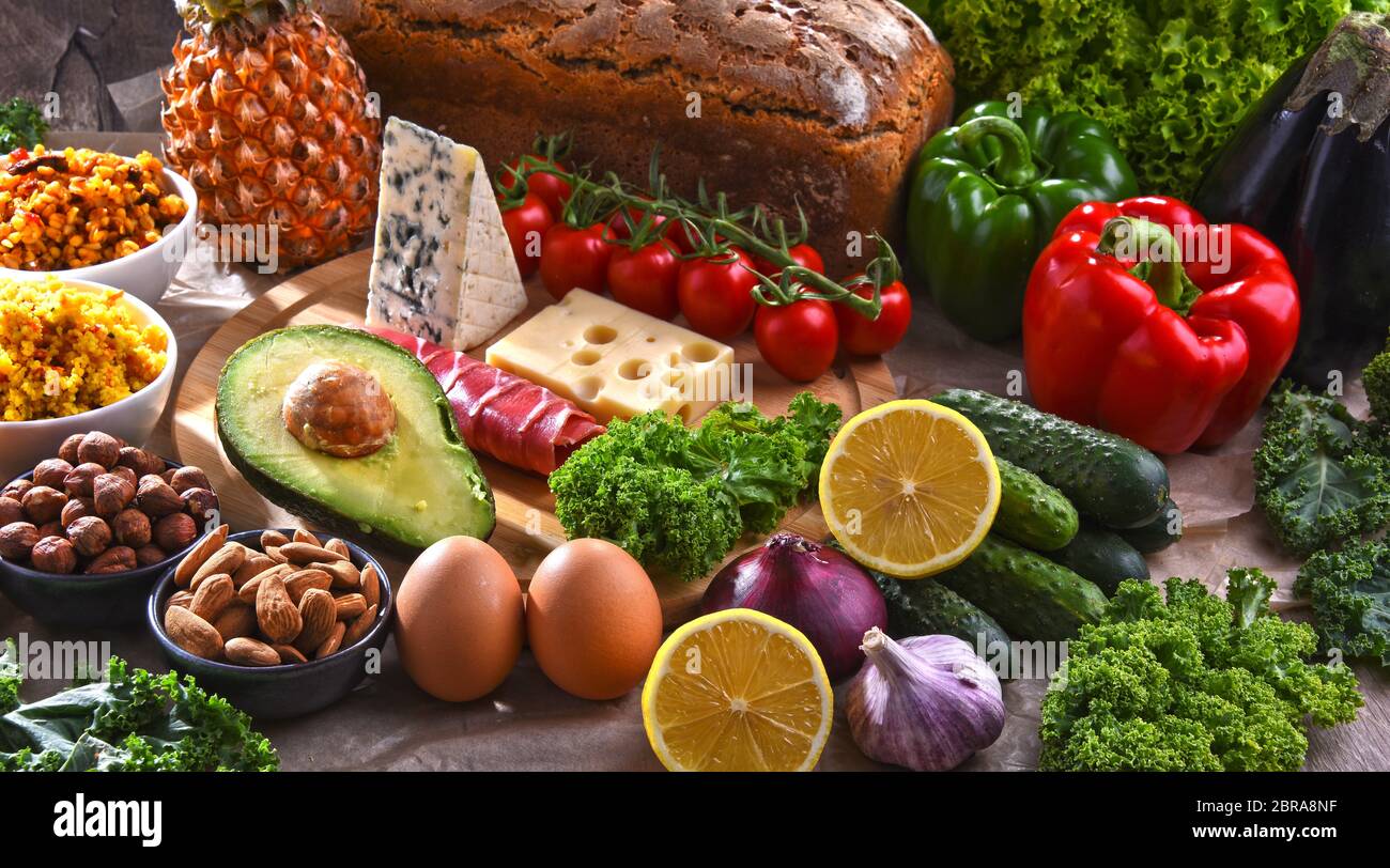 Composition with assorted food products on kitchen table Stock Photo ...