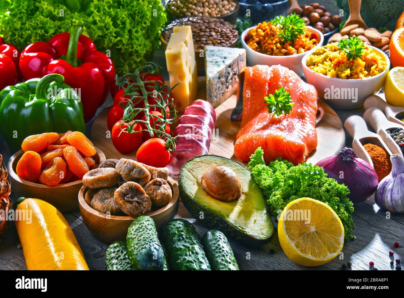 Composition with assorted food products on kitchen table Stock Photo ...