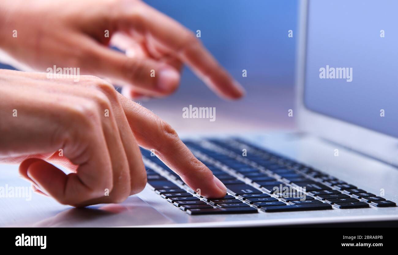 Hands typing on a laptop computer keyboard Stock Photo - Alamy