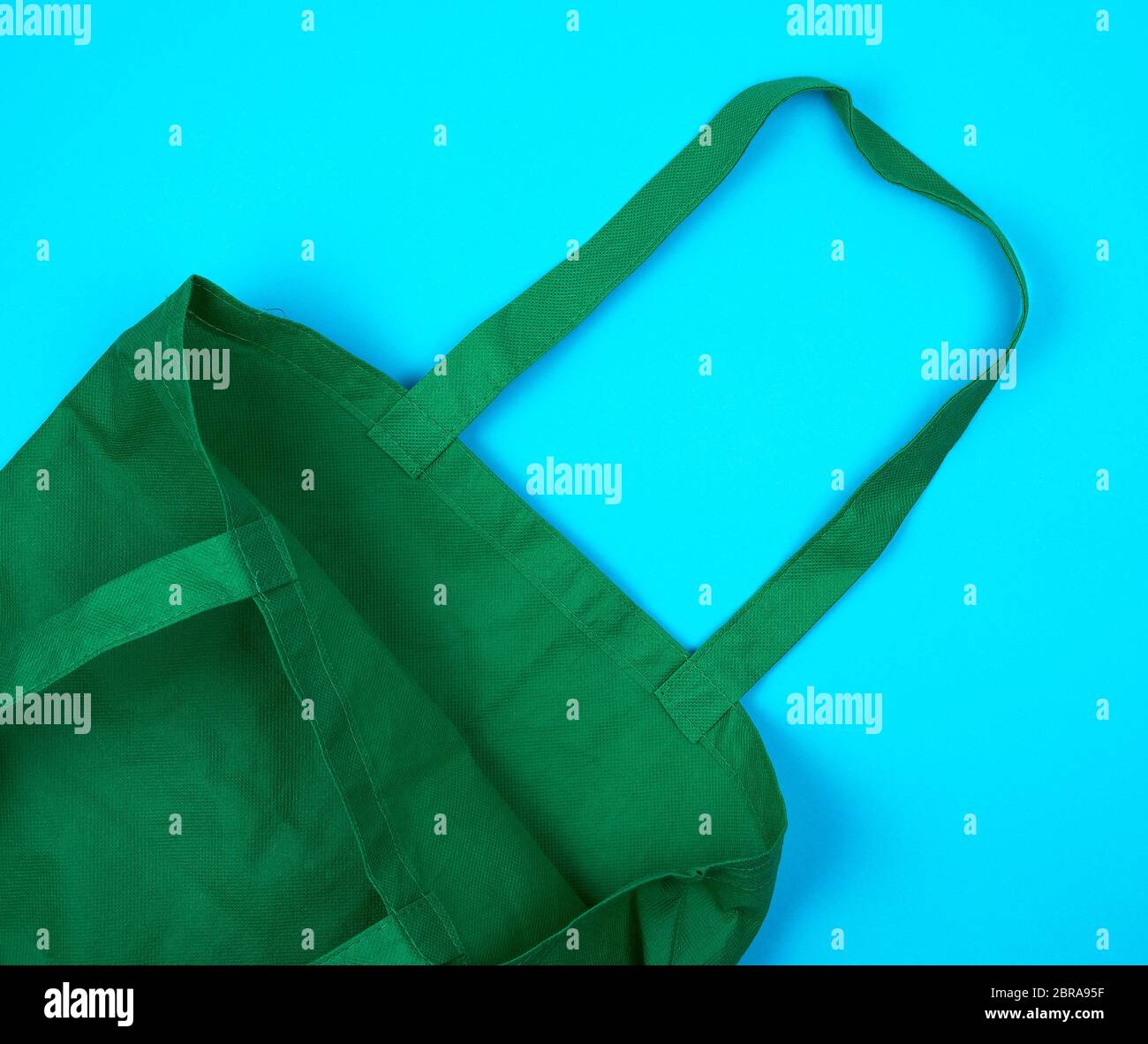 empty green ecological bag made of viscose with long handles, concept ...