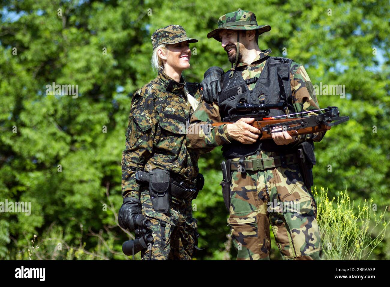 The female and male army soldiers are in different military uniforms ...