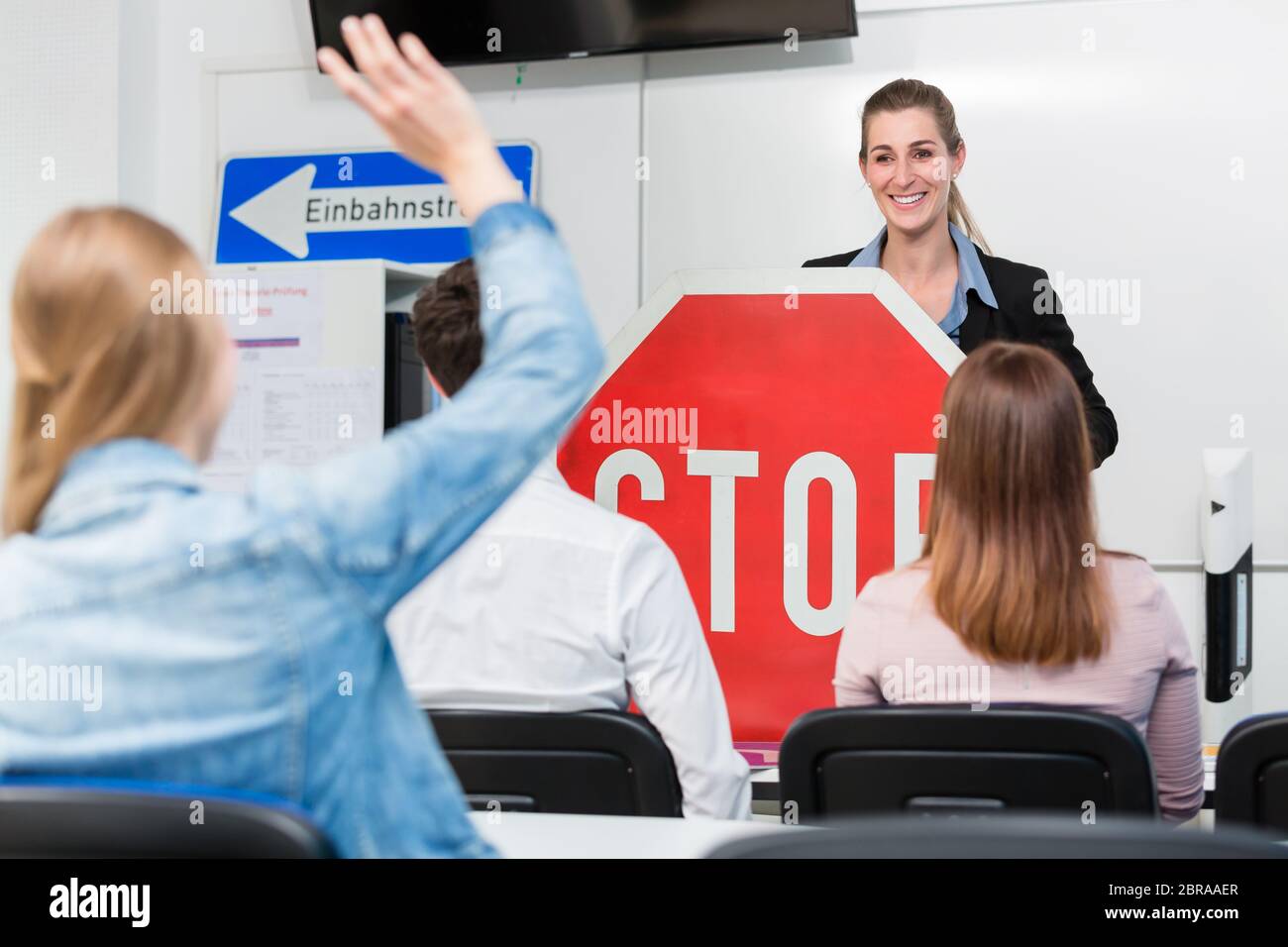 Teacher with class giving driving lessons explain traffic signs Stock ...