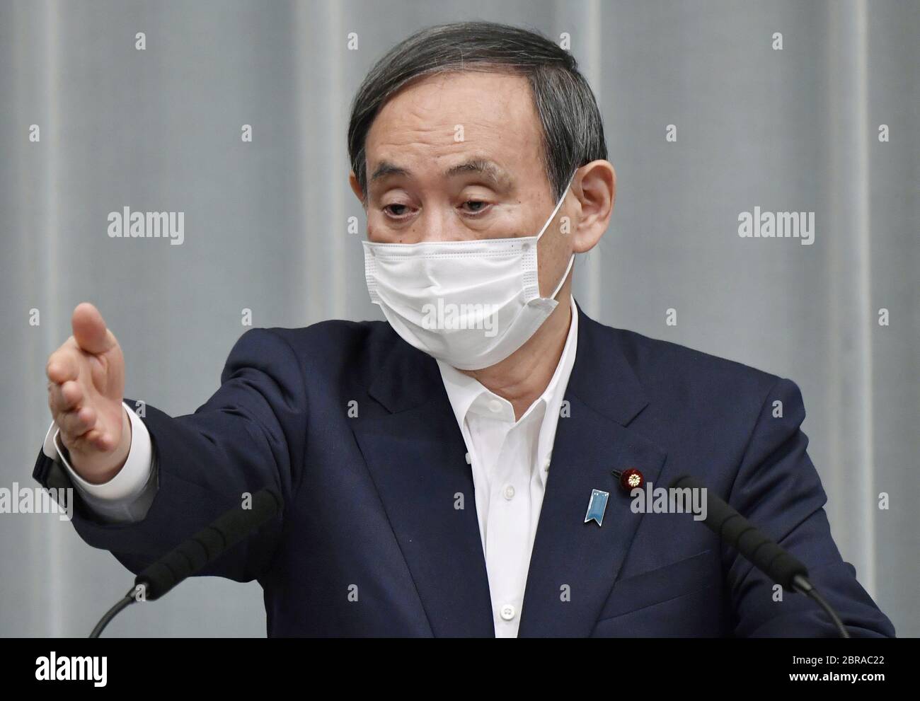 Japanese Chief Cabinet Secretary Yoshihide Suga attends a press ...