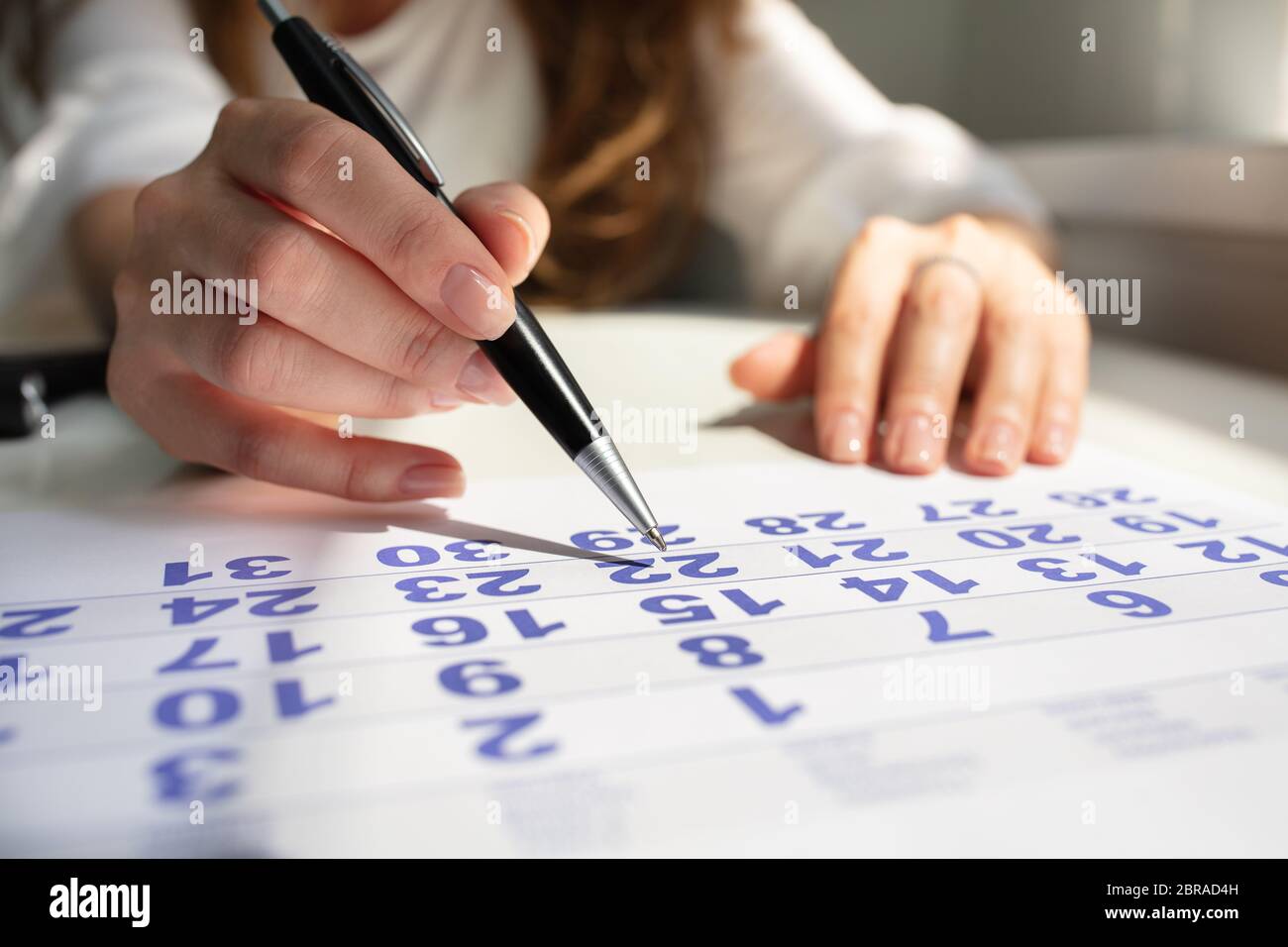 One woman marking the date calendar hi-res stock photography and images ...