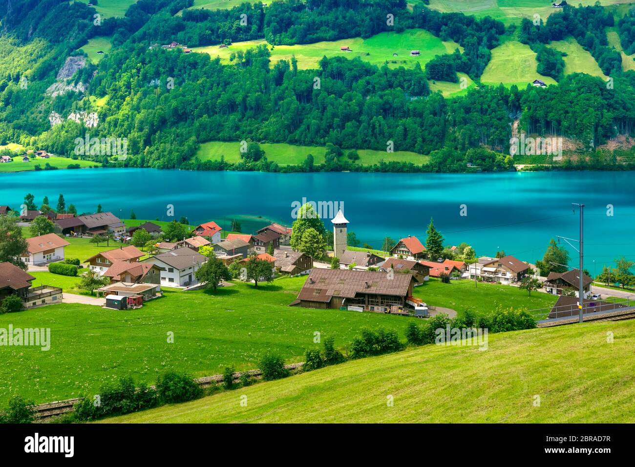 Swiss village Lungern with its traditional houses and old church tower ...