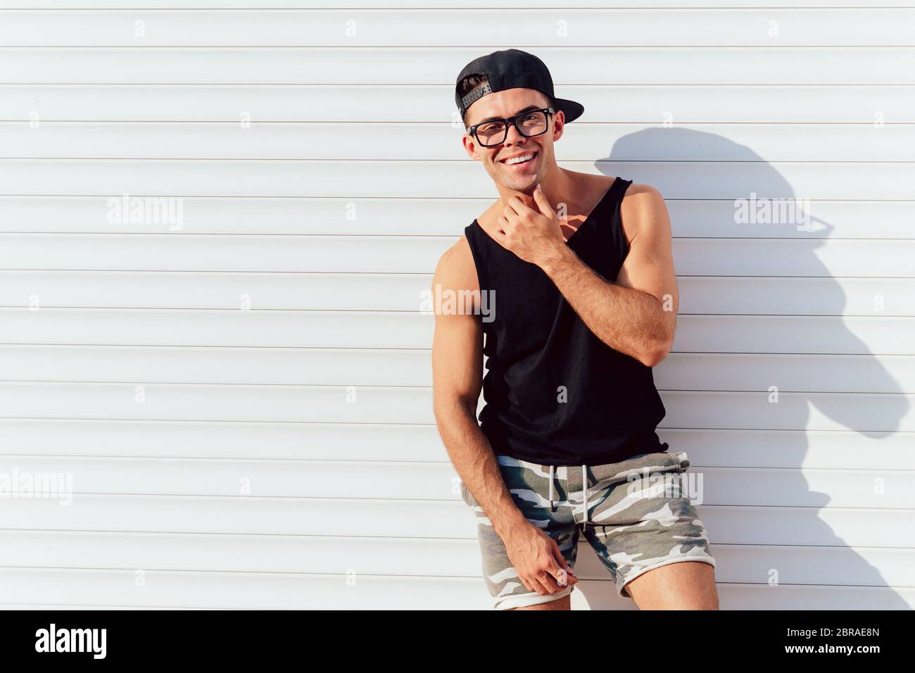 Outdoor photo of trendy young man in stylish clothes, eyeglasses, rap ...