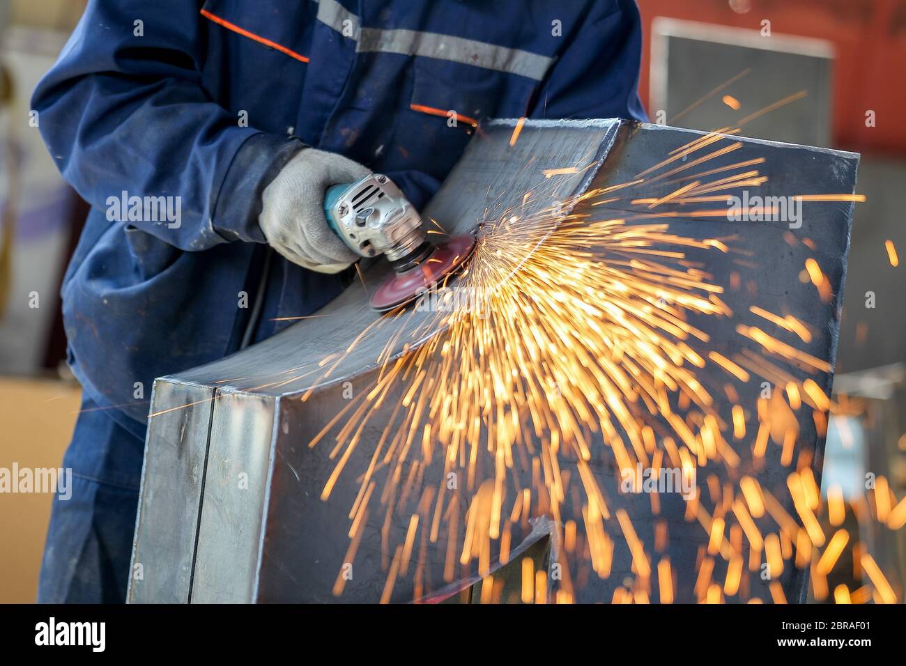 Master grind metal a grinder sparks Stock Photo - Alamy