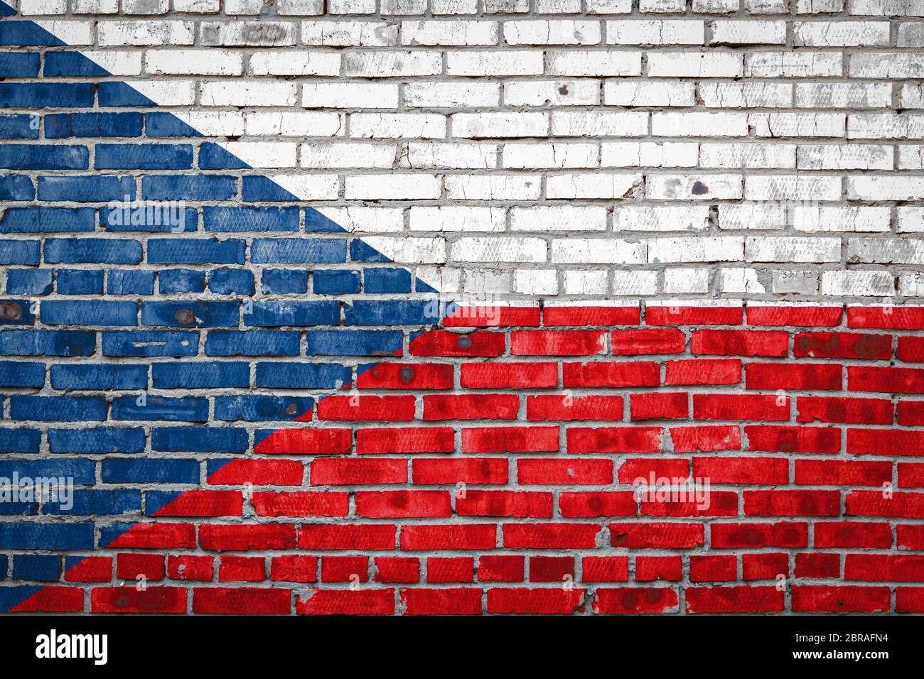National flag of Czech depicting in paint colors on an old brick wall ...