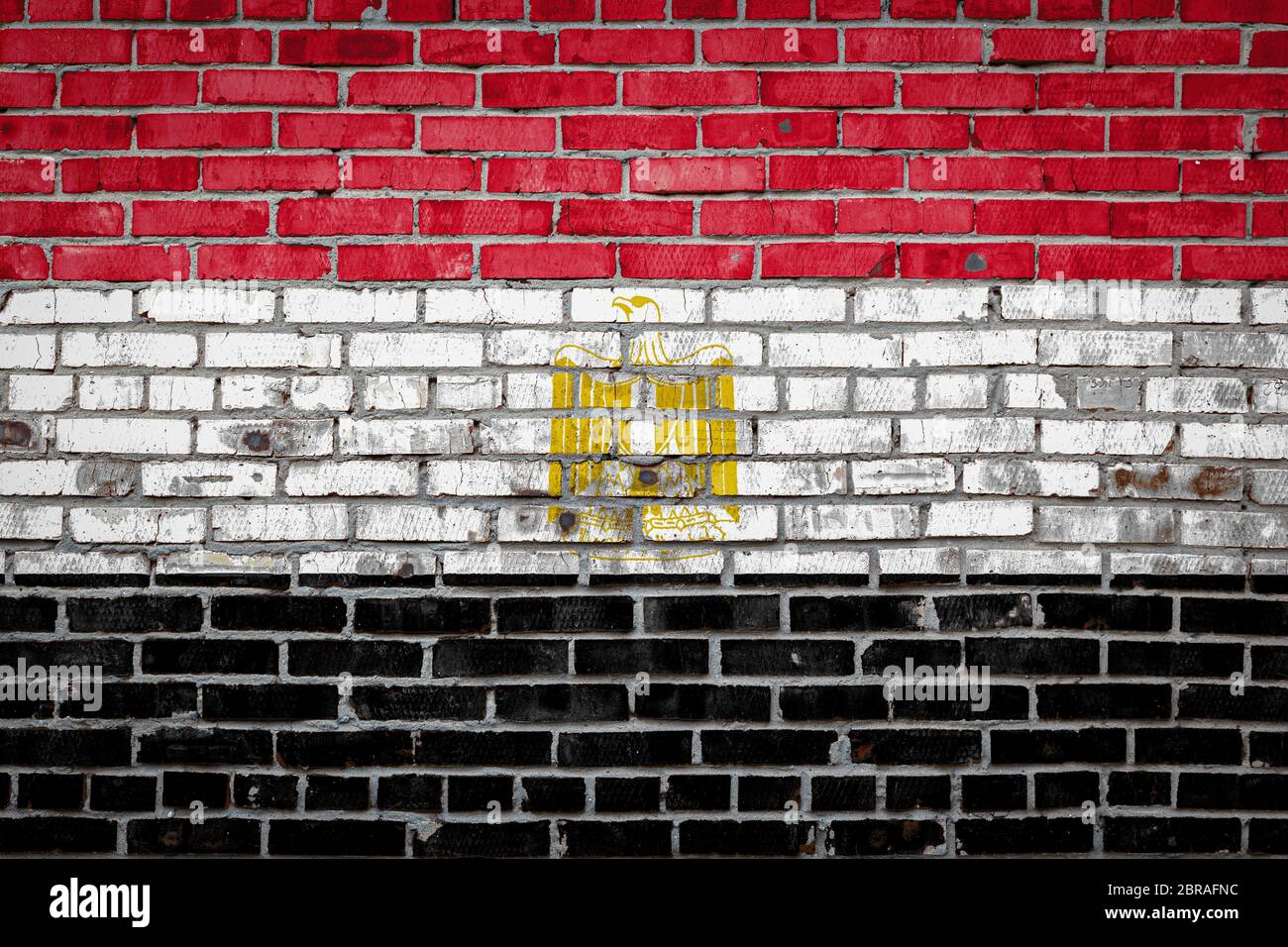 National flag of Egypt depicting in paint colors on an old brick wall ...