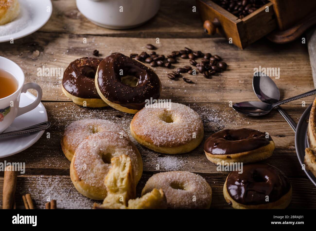 Old style donuts with sugar and dark chocolate, whole table, place for ...