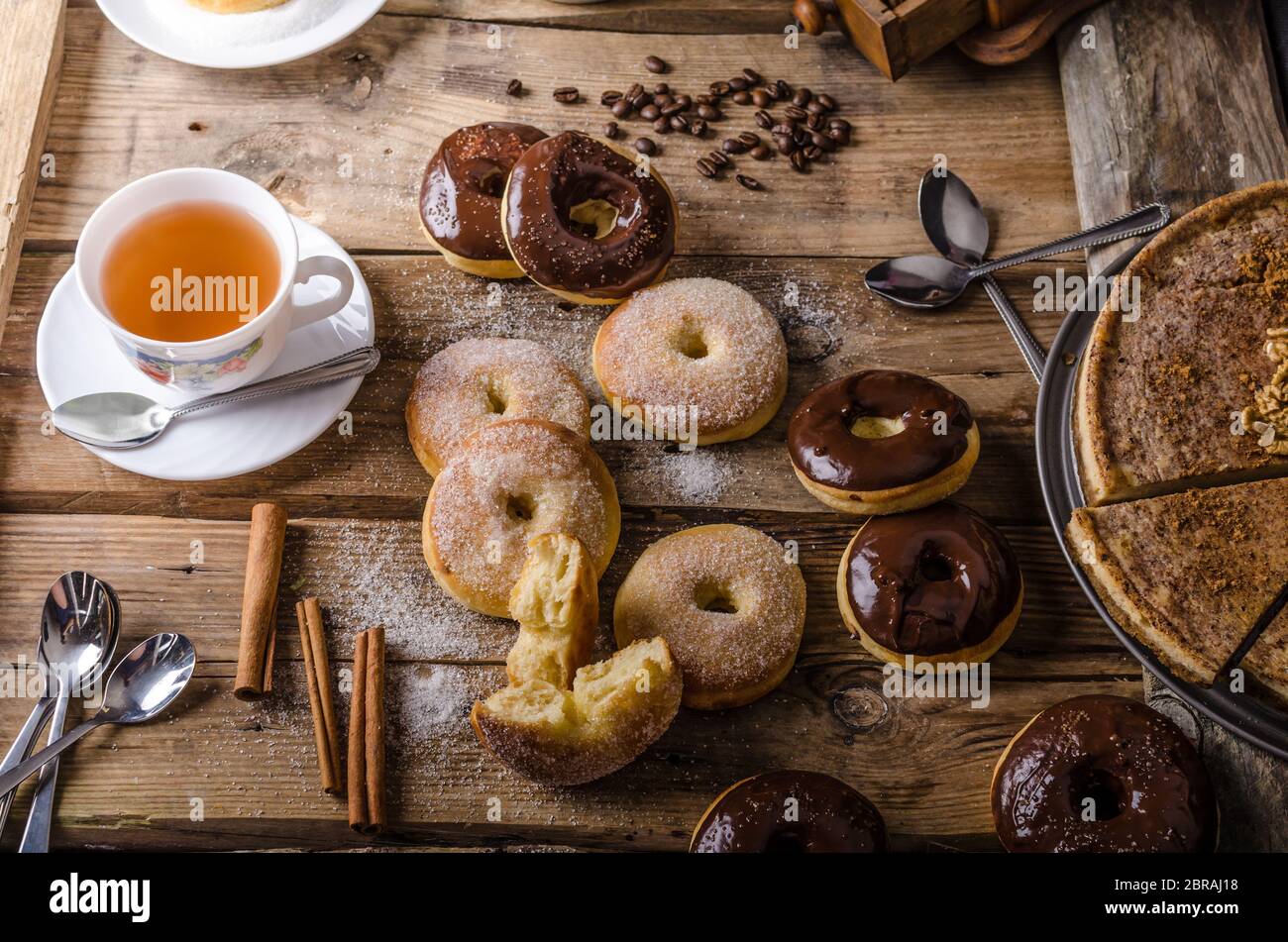 Old style donuts with sugar and dark chocolate, whole table, place for ...
