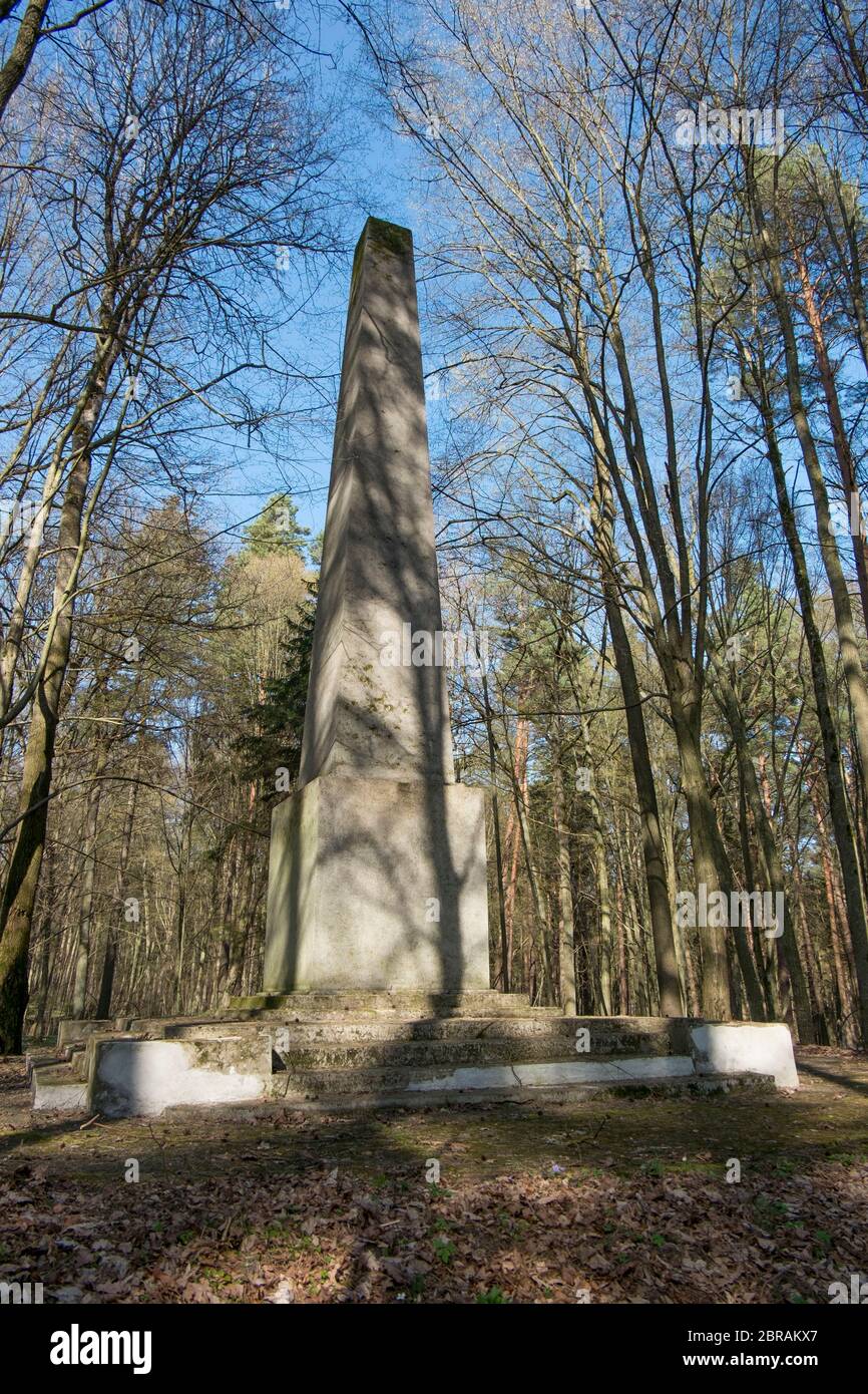 A tall, stone stele. At the Jewish execution, mass grave and memorial ...