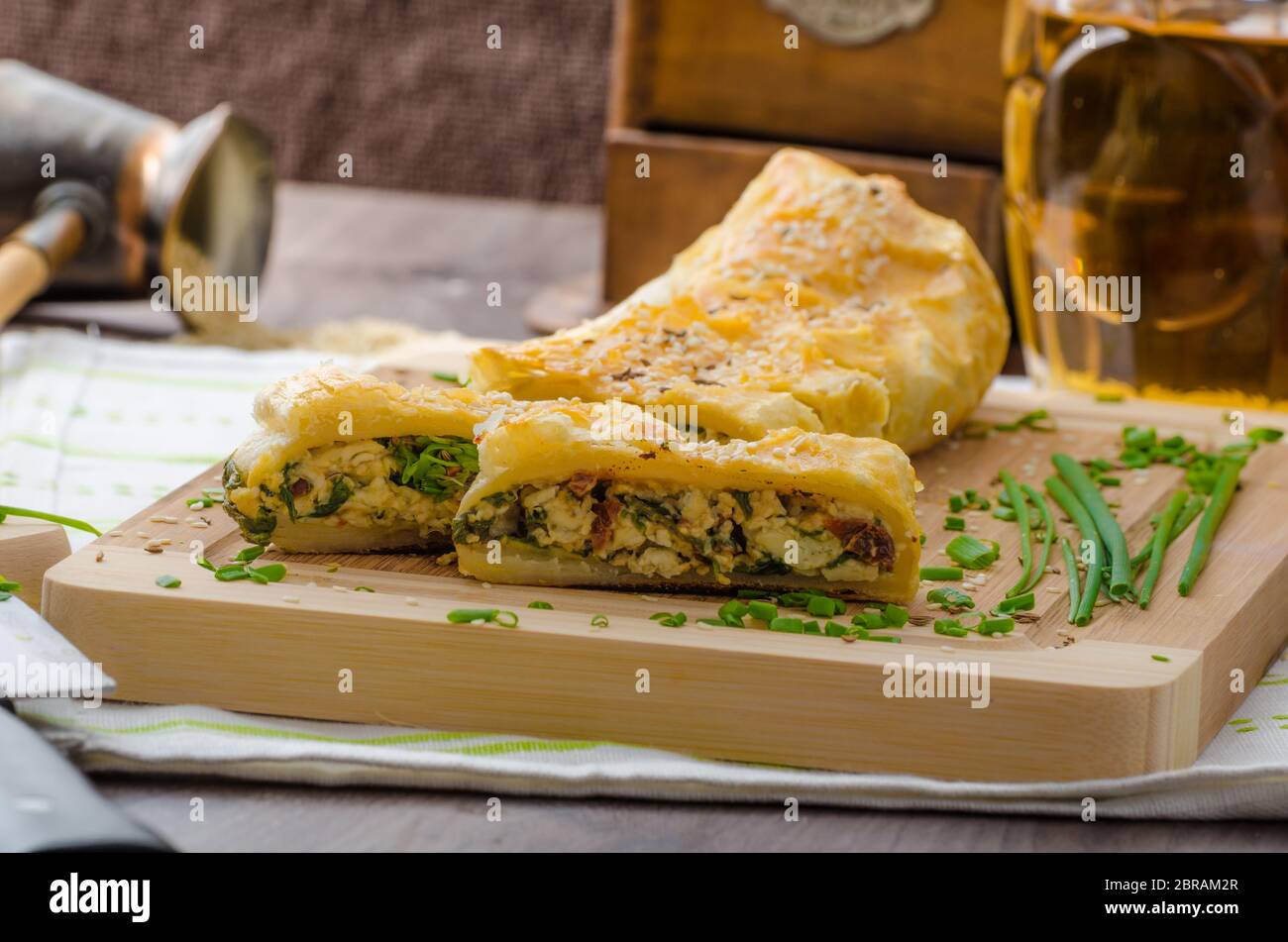 Strudel with spinach, blue cheese and garlic, sprinkled with chive and ...