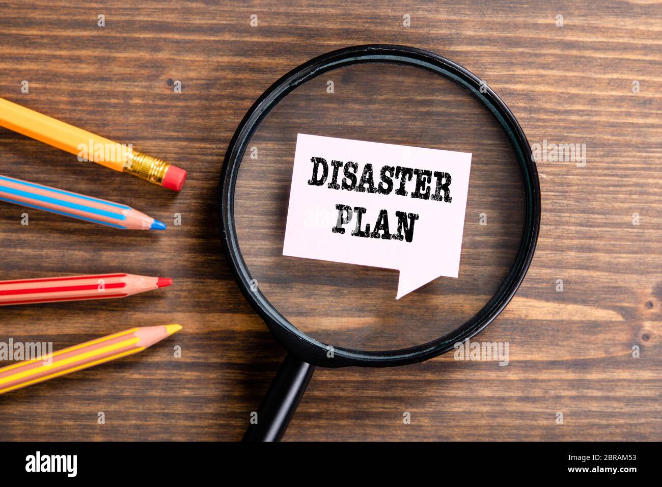 DISASTER PLAN concept. Black magnifying glass, speech bubble and ...