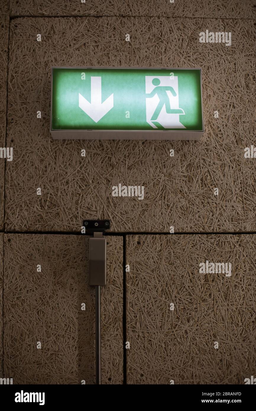 Color image of a green exit sign above a door Stock Photo - Alamy