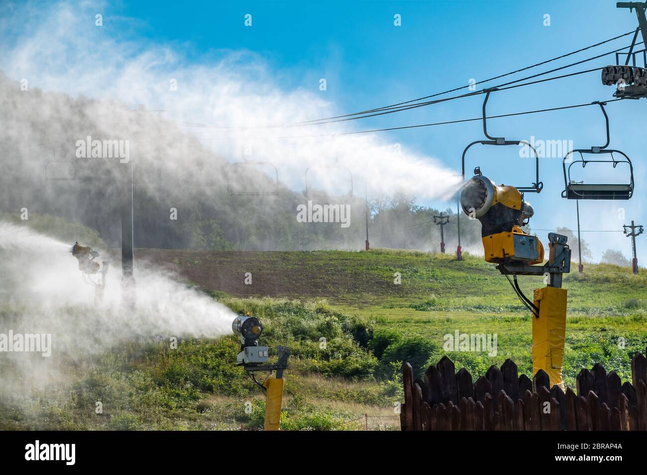 Snow gun in the summer in the mountain ski resort. A hillside snowmaker ...