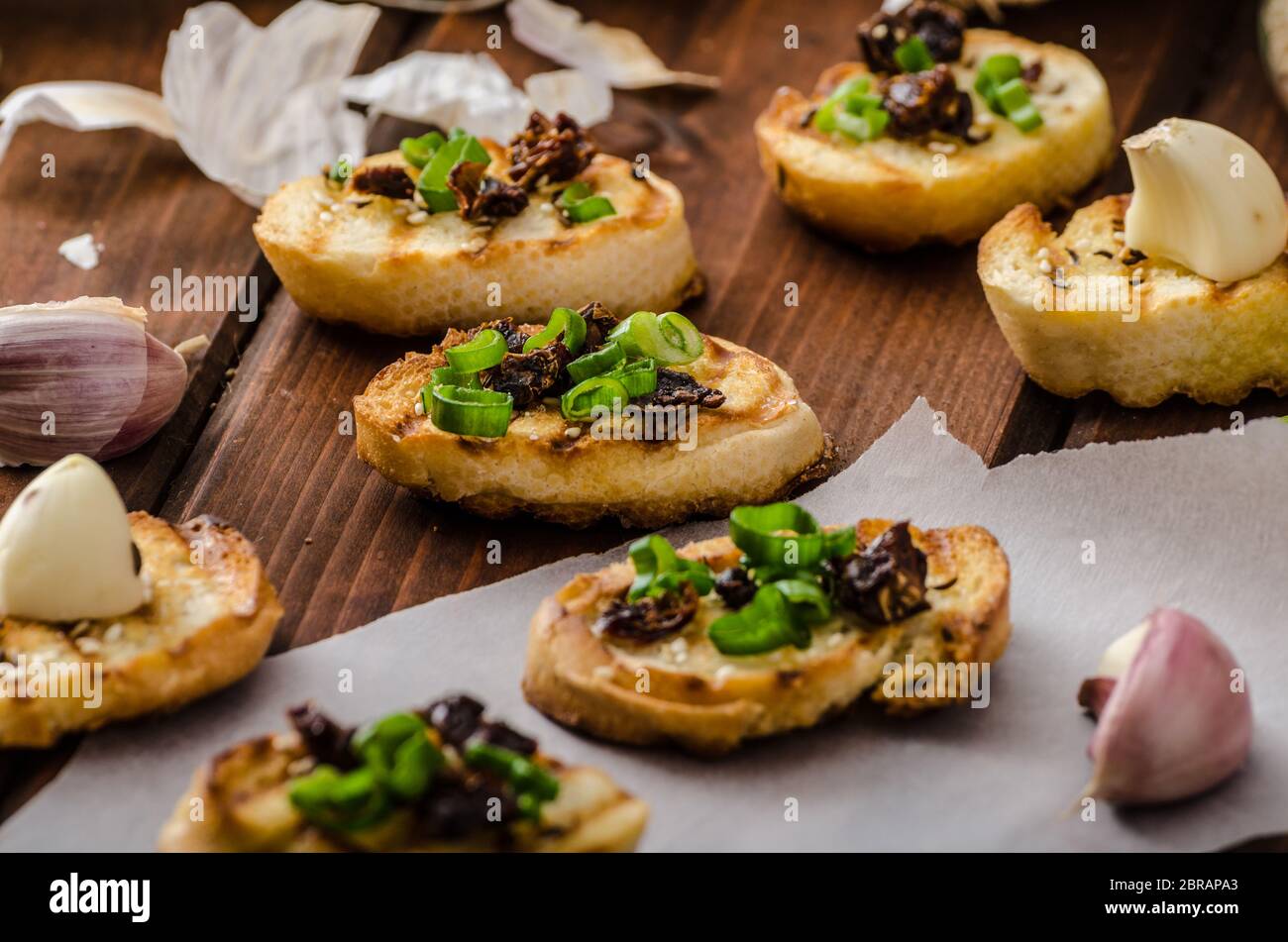 Mini toasts with garlic and dried tomato, sprinkled with herbs Stock ...