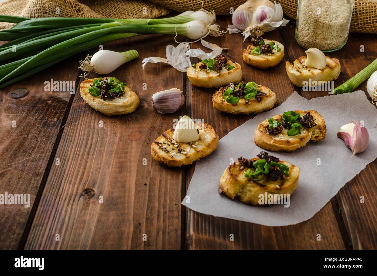 Mini toasts with garlic and dried tomato, sprinkled with herbs Stock ...