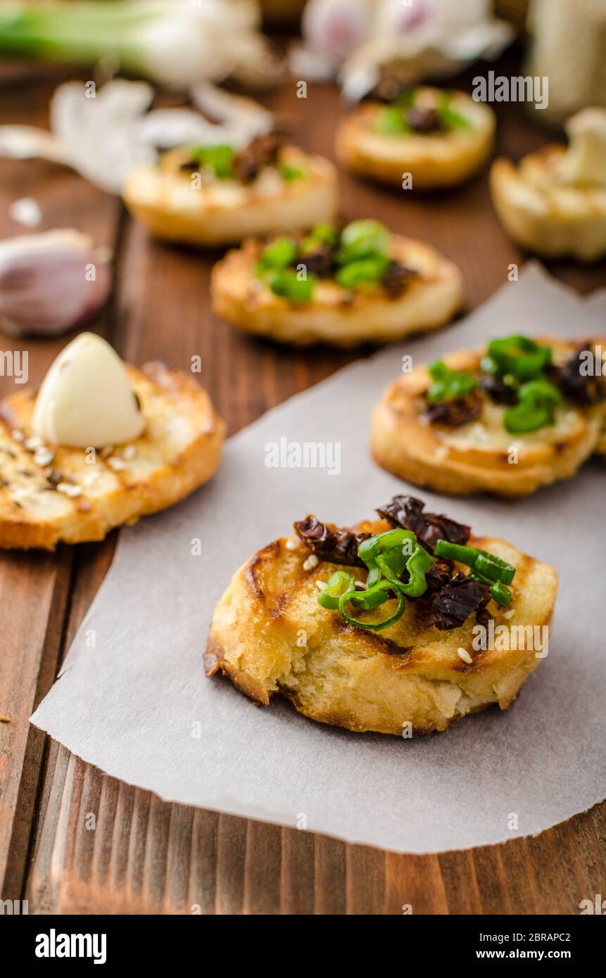 Mini toasts with garlic and dried tomato, sprinkled with herbs Stock ...