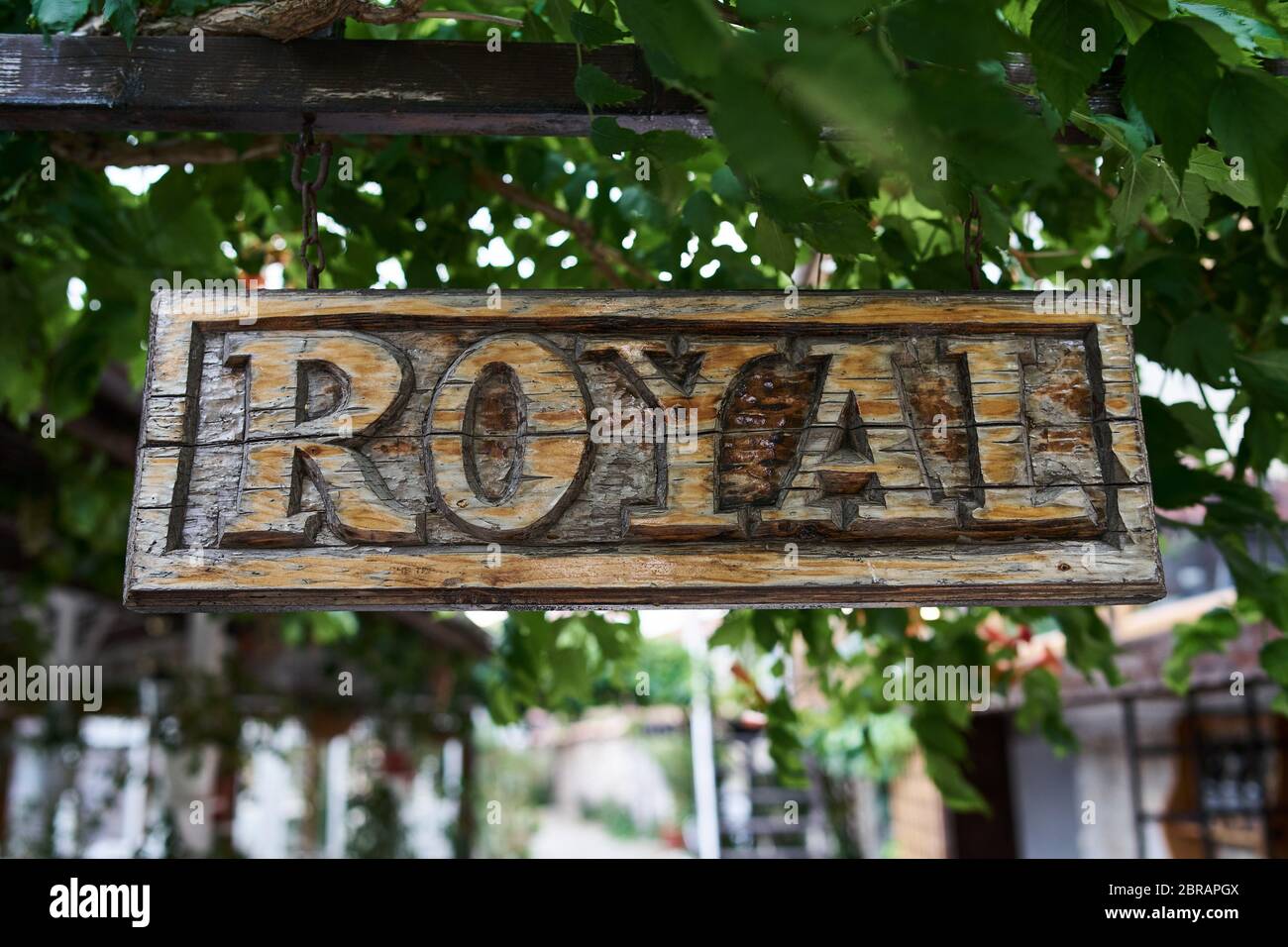 Wood carving. Old wooden signboard with the words "Royal Stock Photo ...
