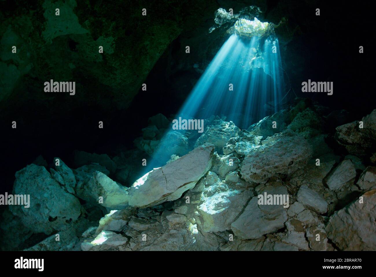 Rays Of Sun Coming From A Crack In The Stone In The Cenote Tajma Ha