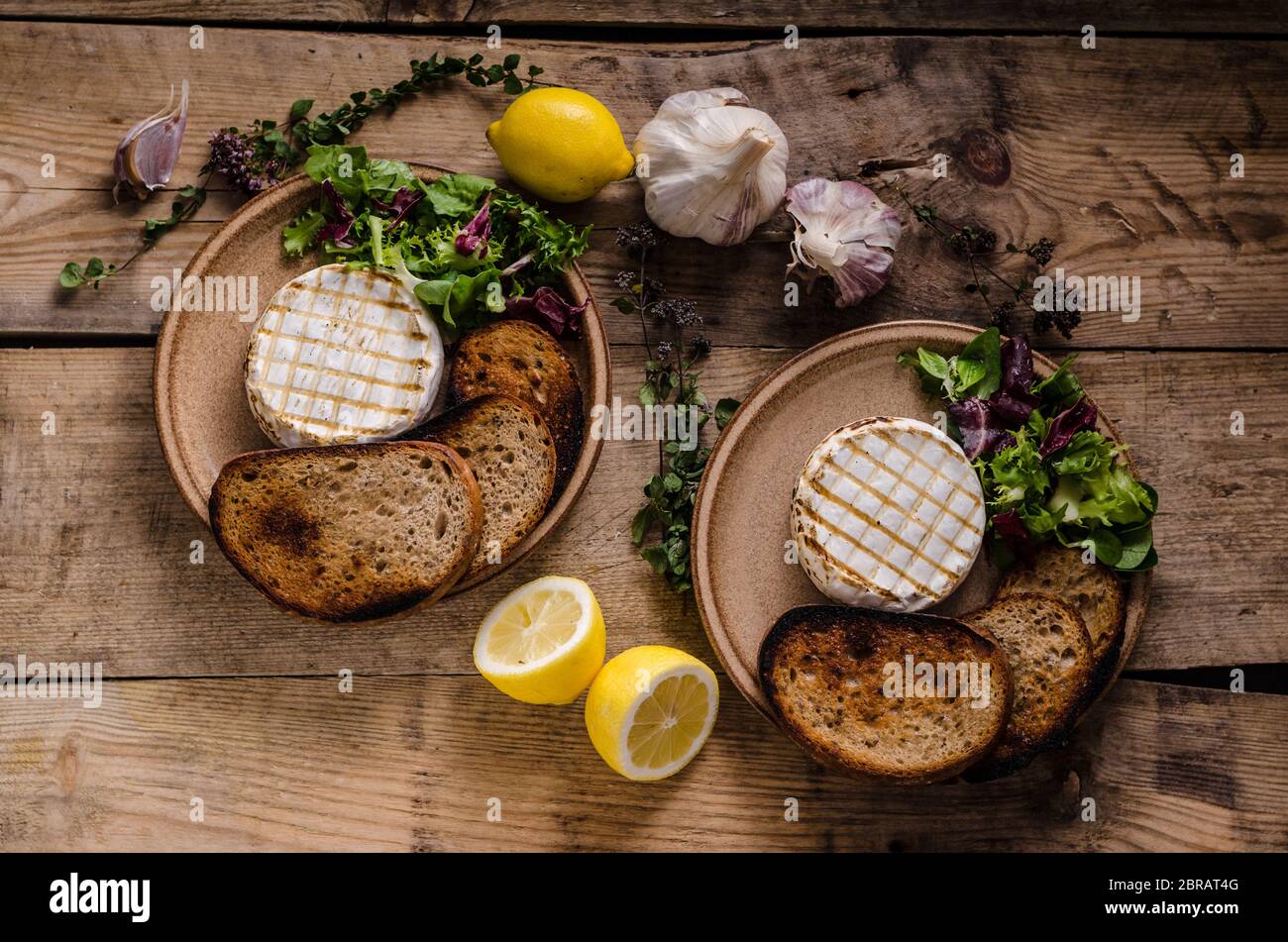 Grilled camembert cheese, mini salad and baked bread Stock Photo - Alamy