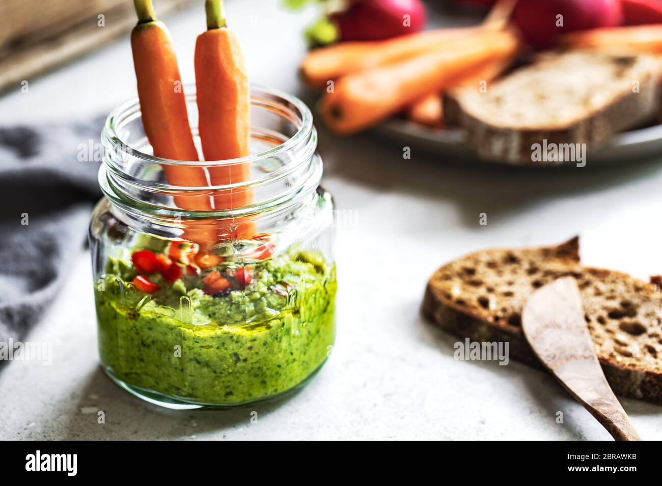 Spinach Hummus in a glass jar by baby Carrot and Rye bread Stock Photo ...