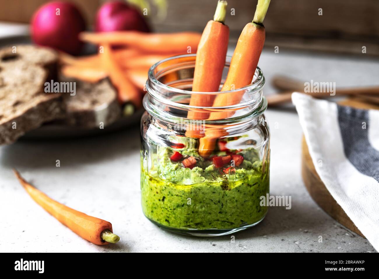 Spinach Hummus in a glass jar by baby Carrot and Rye bread Stock Photo ...