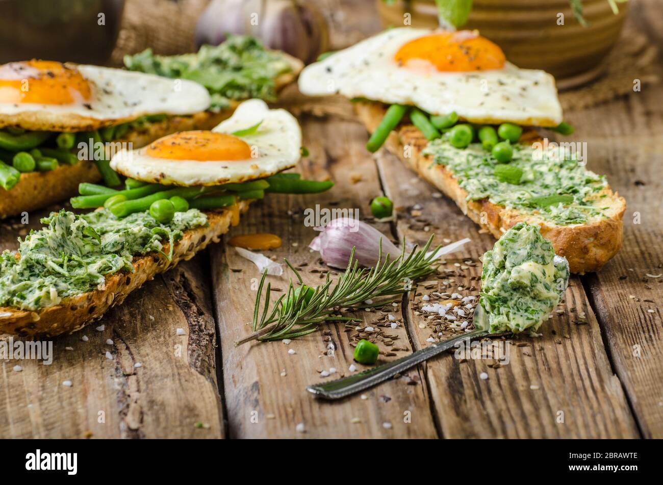 Healthy rustic baguette with herb butter and vegetables Stock Photo - Alamy