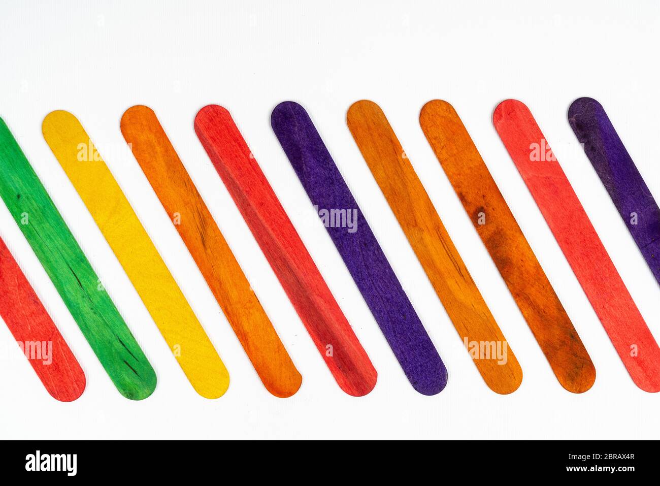 row of colored wooden slats on a white surface Stock Photo - Alamy