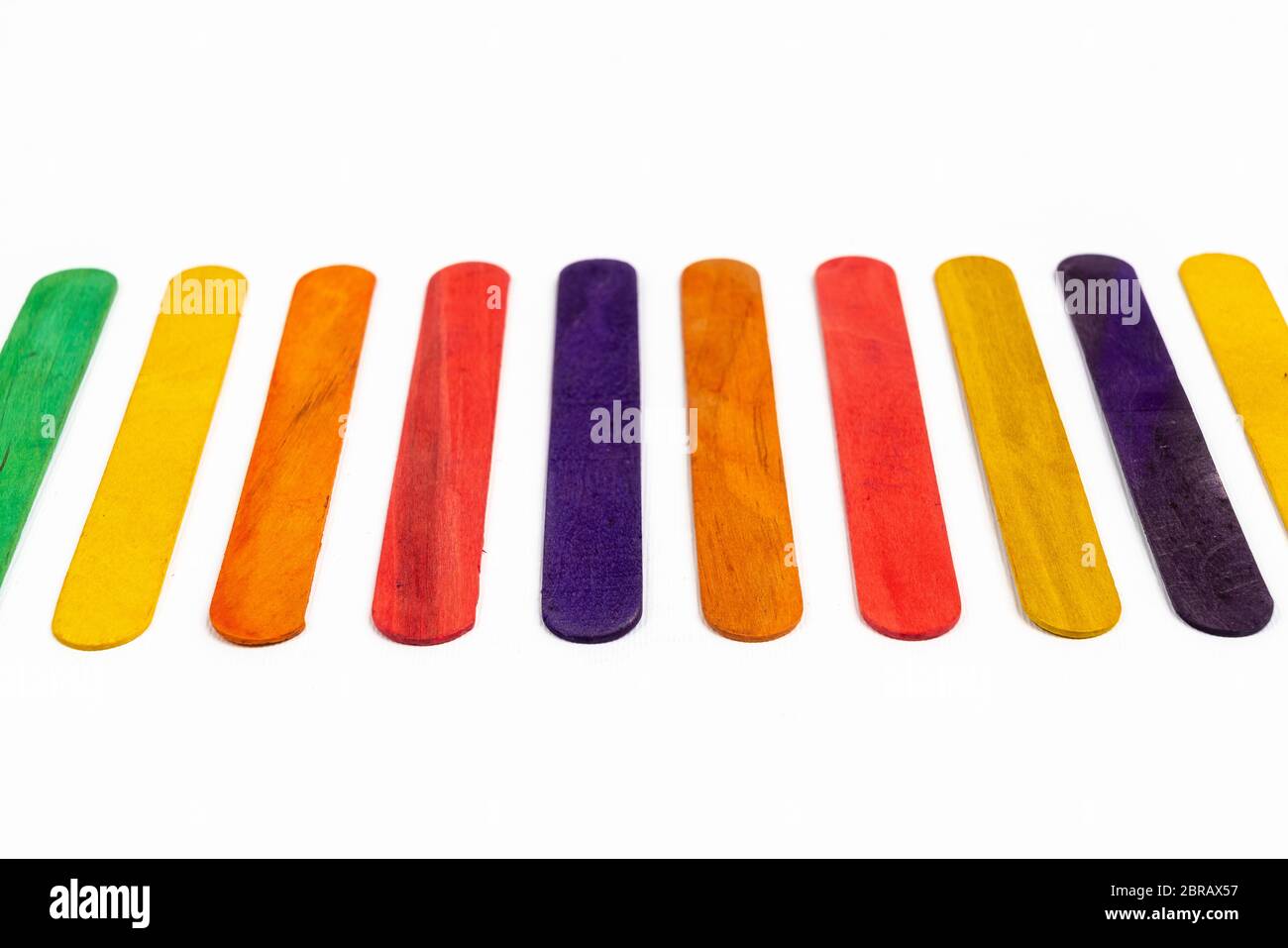 row of colored wooden slats on a white surface Stock Photo - Alamy