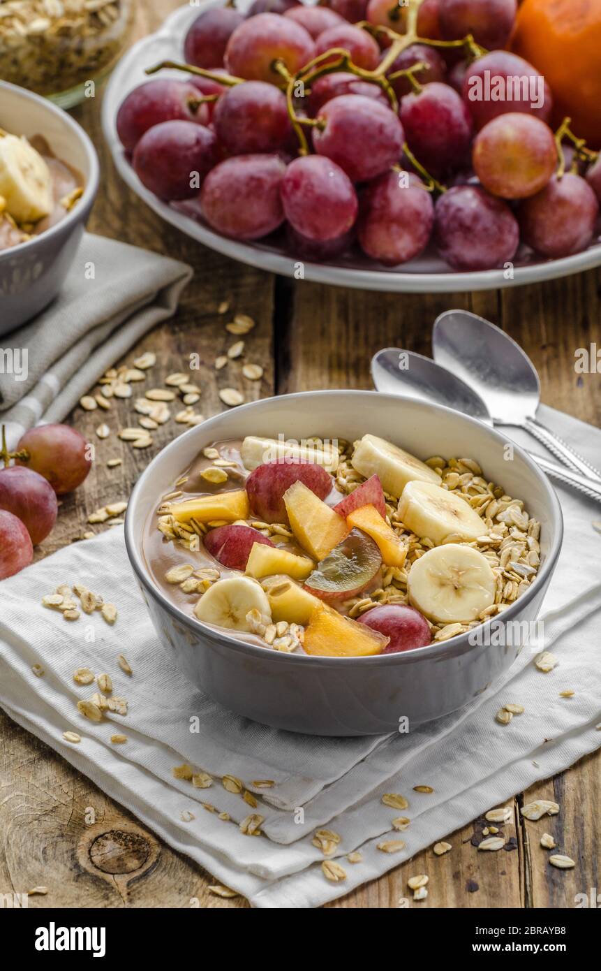 Homemade granola with fruit and chocolate. Fruit - kaki, red grape ...