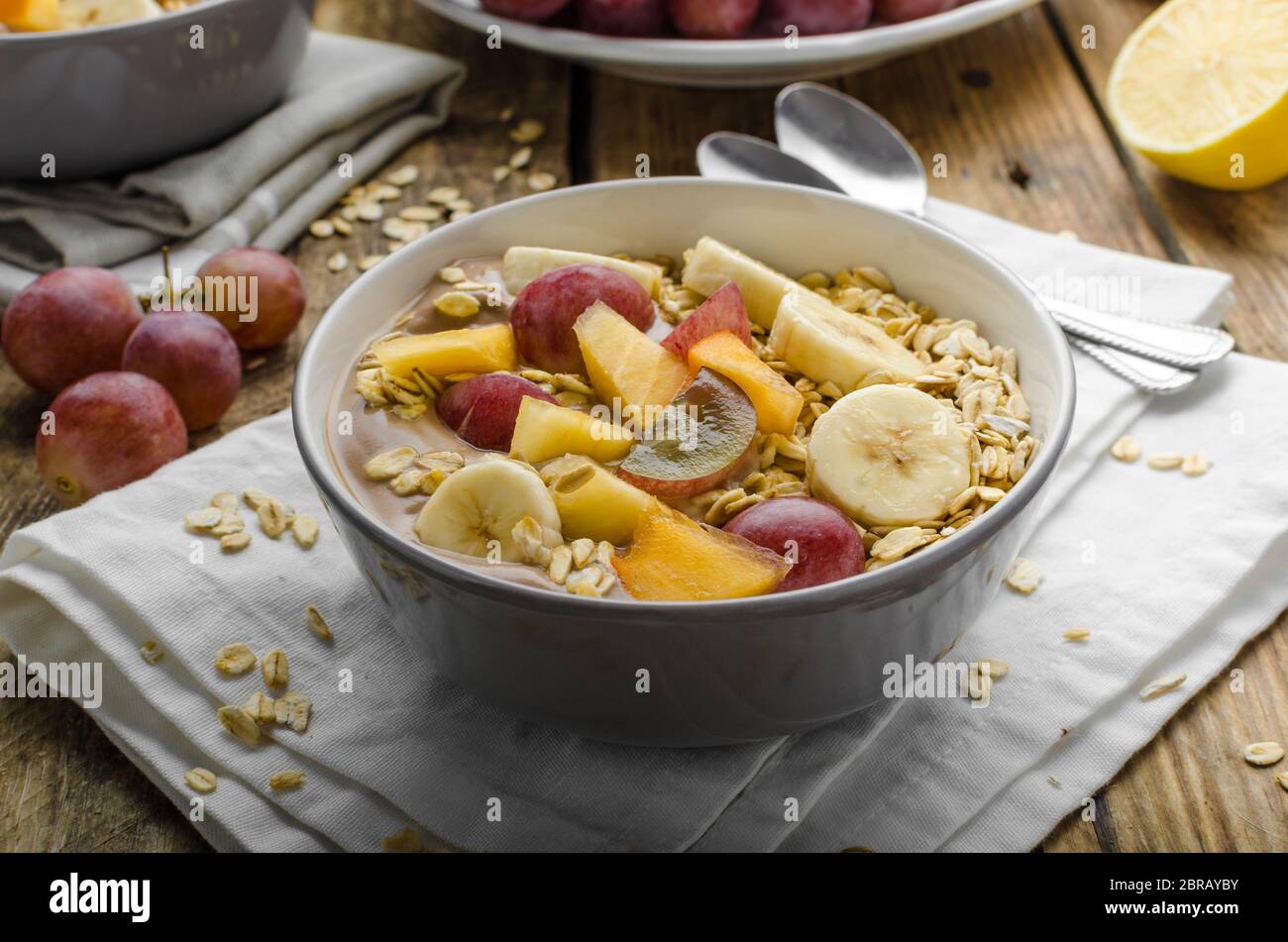 Homemade granola with fruit and chocolate. Fruit - kaki, red grape ...