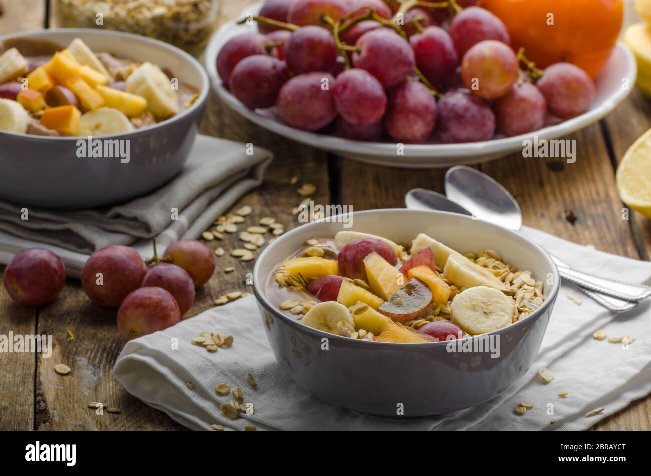 Homemade granola with fruit and chocolate. Fruit - kaki, red grape ...