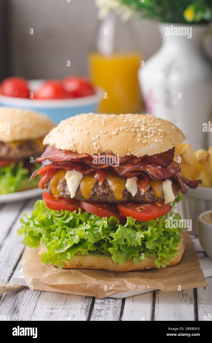 Homemade bacon burger with lettuce and cheddar, homemade potato french ...