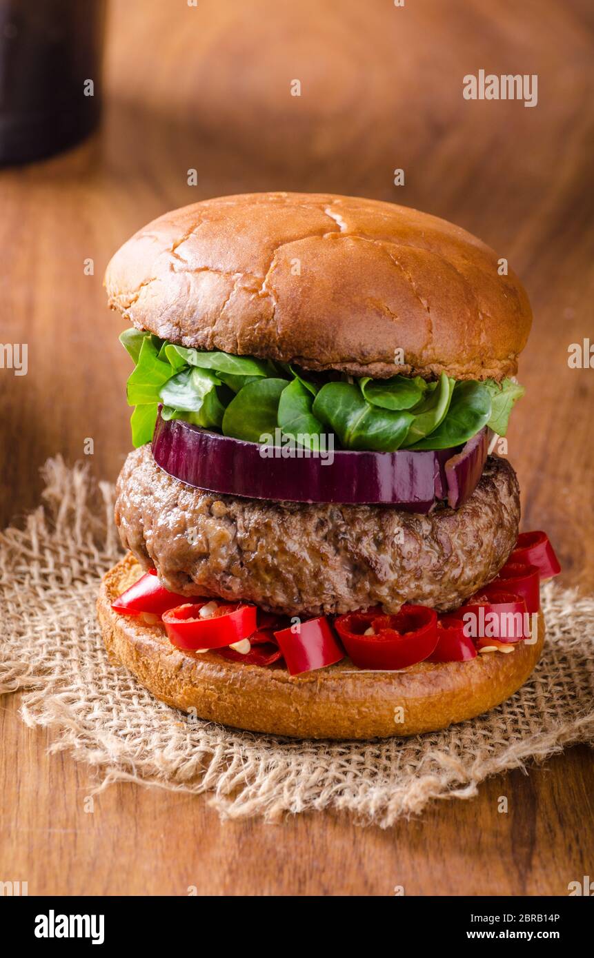 Beef burger with chilli, homemade bun and delicious beef seasoned meat ...