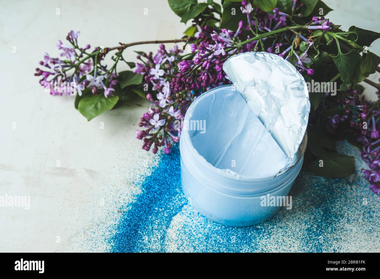 large blue jar with a moisturizing and cleansing cream for the skin and ...