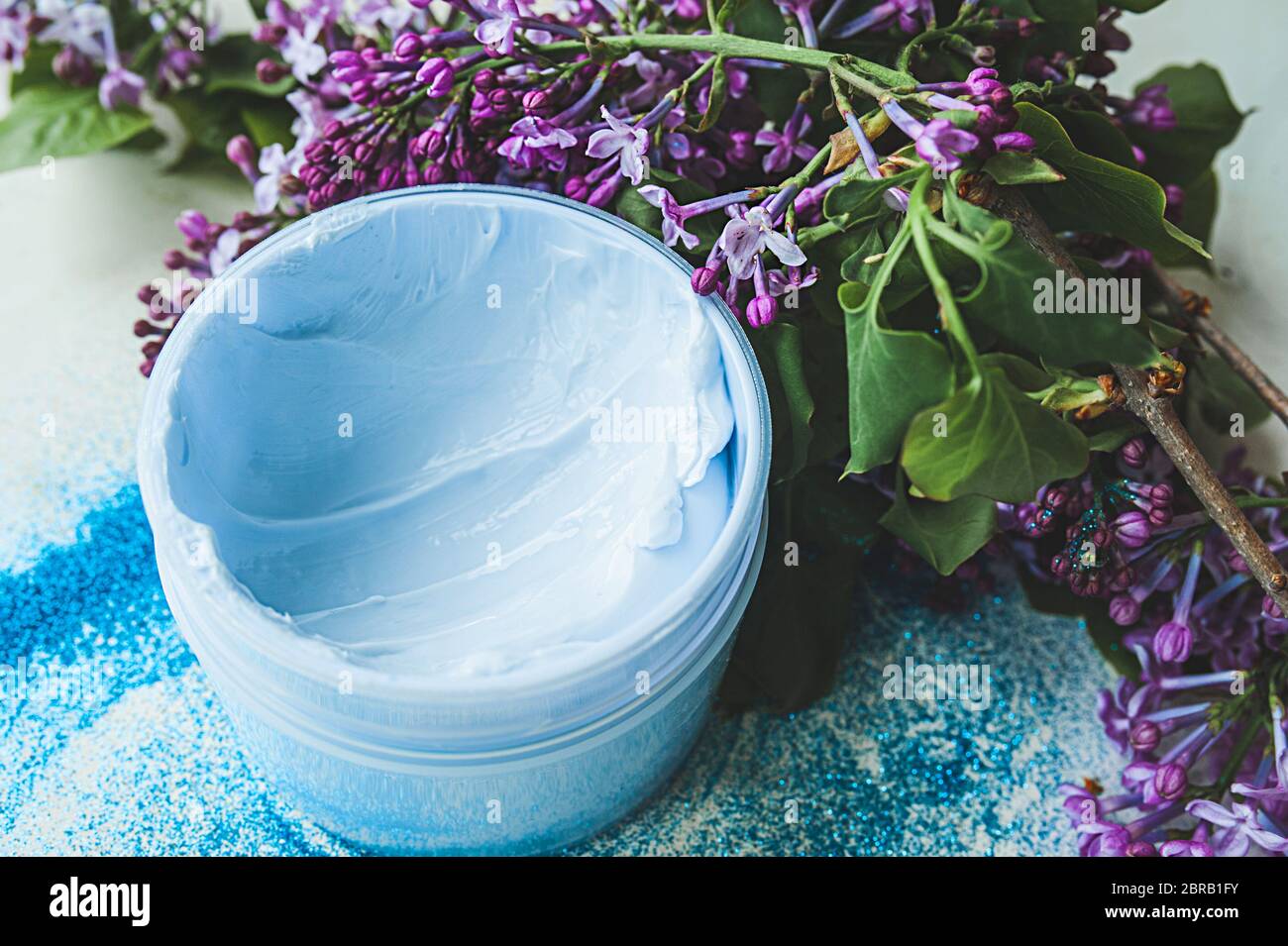 open large blue jar with a moisturizing and cleansing cream for the ...