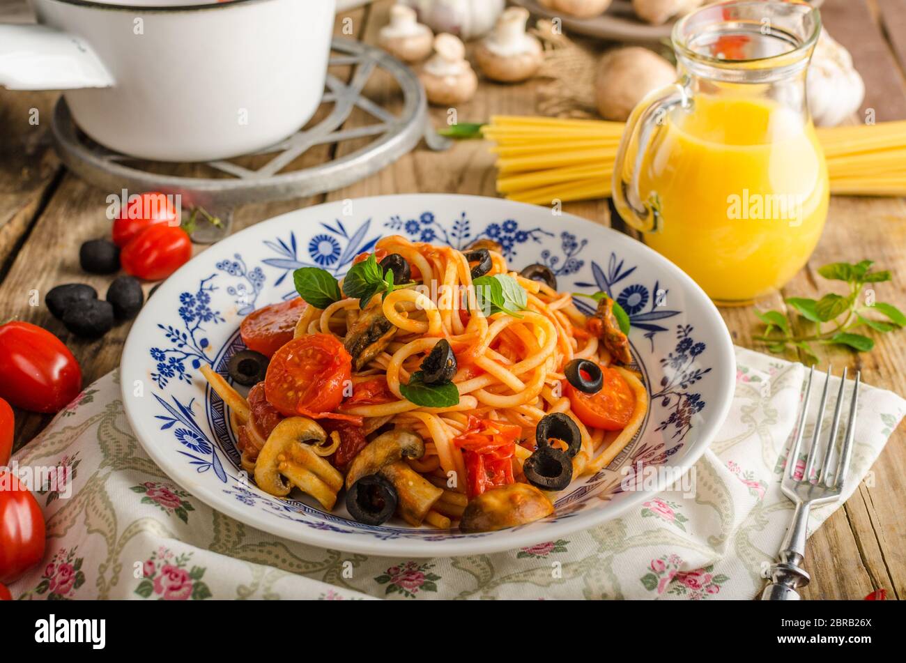 Pasta with olives, tomatoes and basil, fresh pasta, orange juice Stock ...