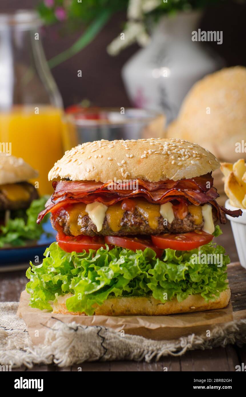 Homemade bacon burger with lettuce and cheddar, homemade potato french ...